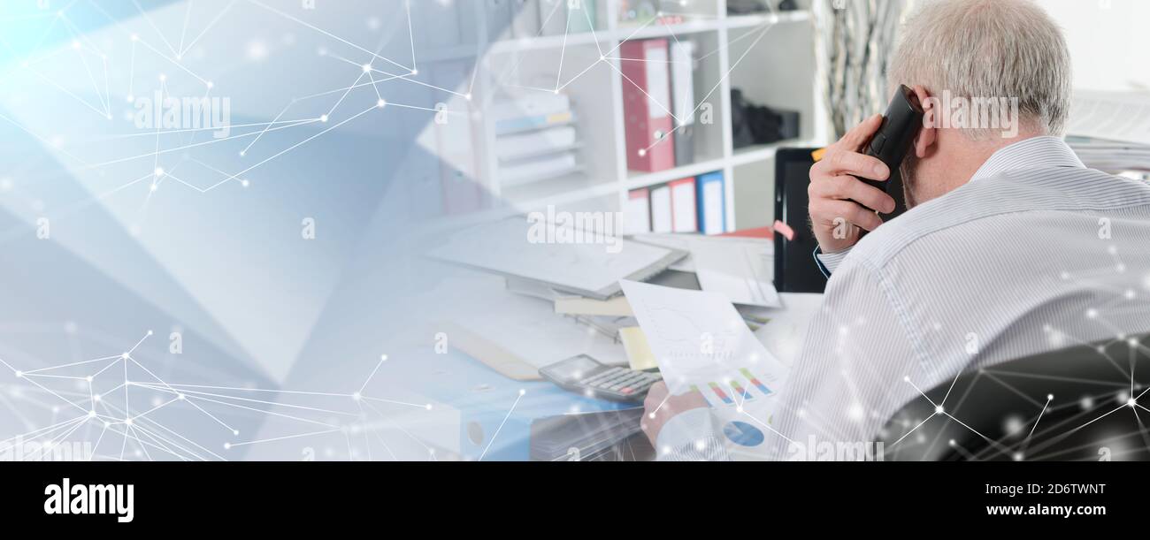 Businessman working at an untidy and cluttered desk; multiple exposure ...