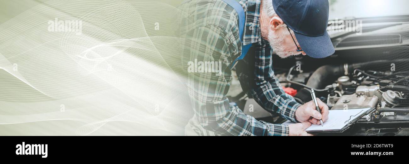Car mechanic checking a car engine and writing on clipboard; panoramic ...