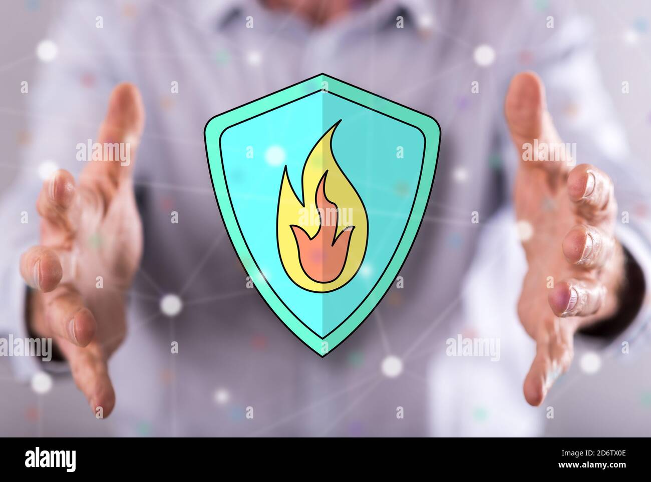 Fire protection concept between hands of a man in background Stock ...