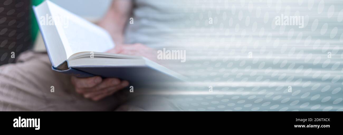 Man sitting outdoor reading a book; panoramic banner Stock Photo - Alamy