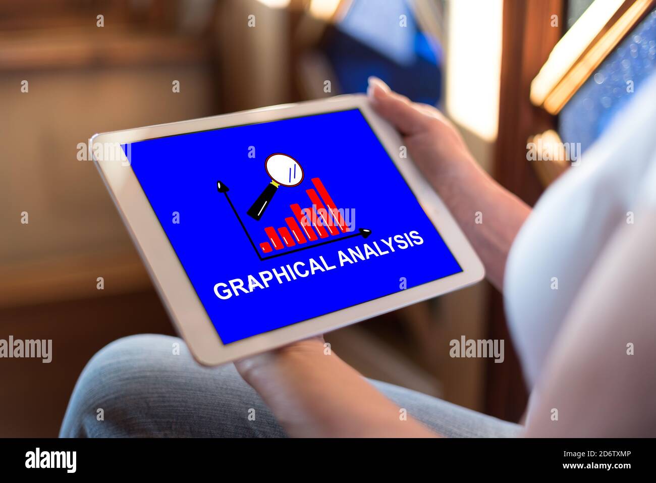 Woman holding a tablet showing graphical analysis concept Stock Photo ...