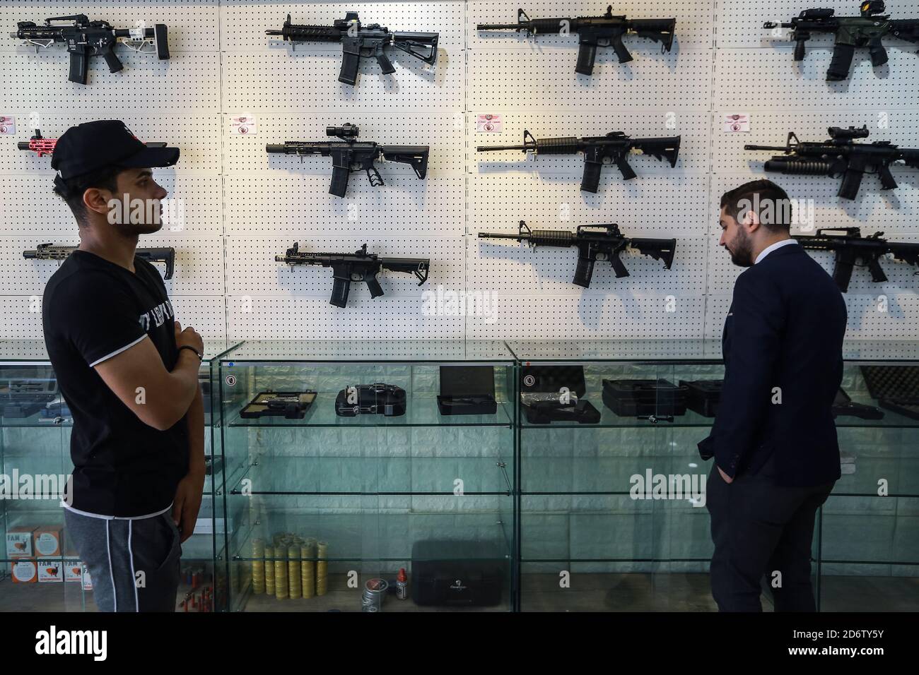 Najaf, Iraq. 19th Oct, 2020. An arms dealer (L) shows a customer a ...