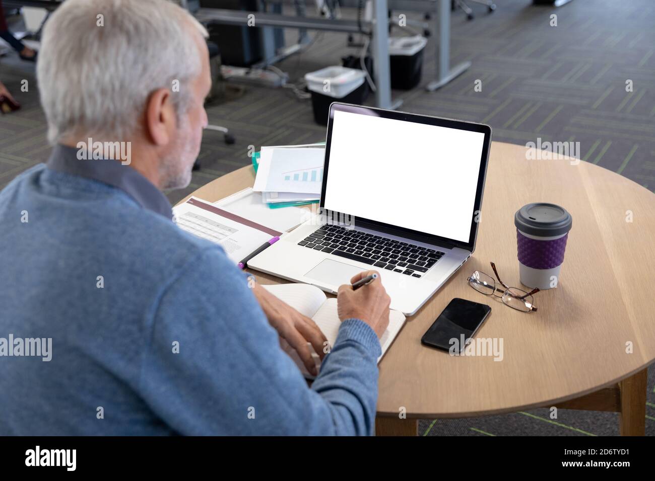 Businessman using laptop taking notes hi-res stock photography and ...