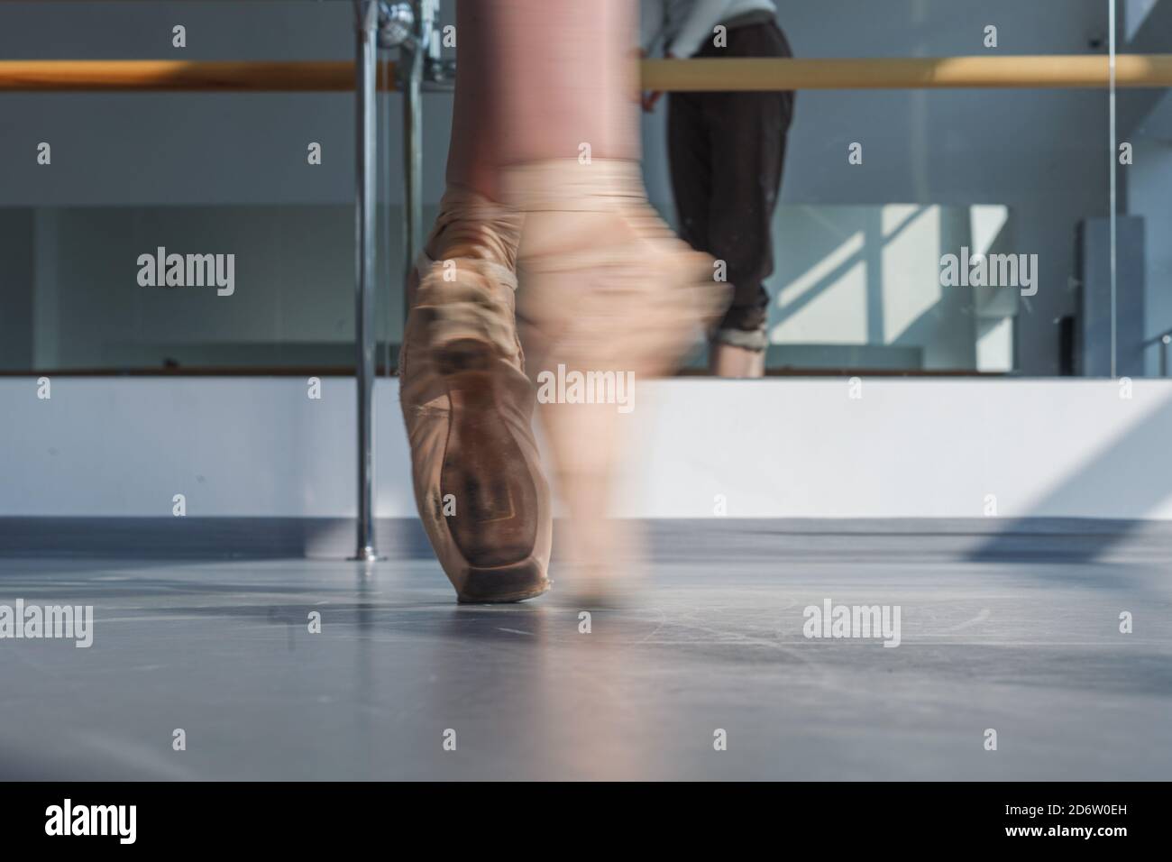 female ballet dancer feet in pointe shoes turning with motion blur in ...