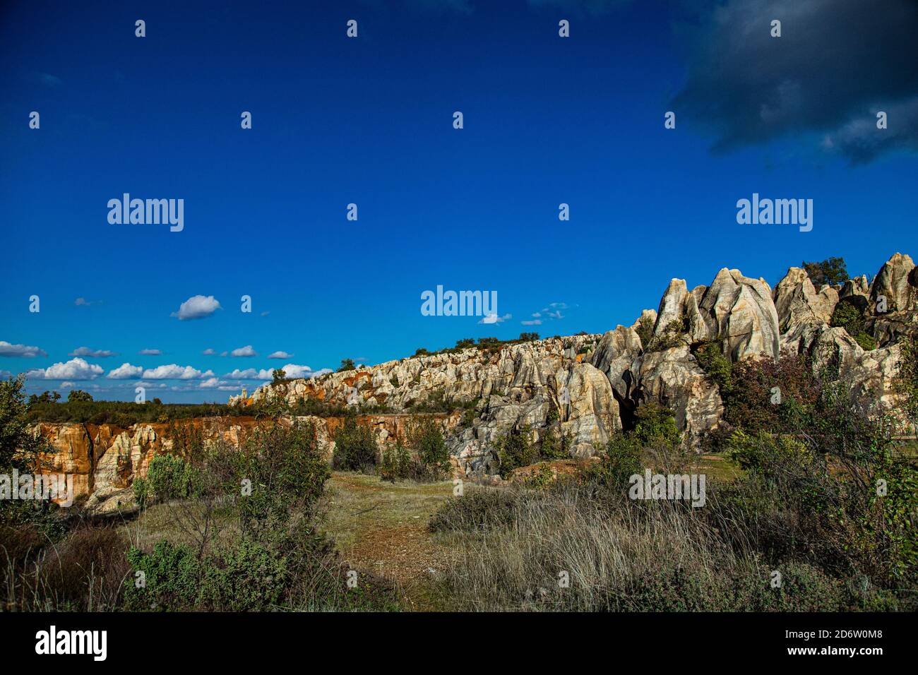 Spiky granite rock forms in landscape with blue sky Stock Photo - Alamy