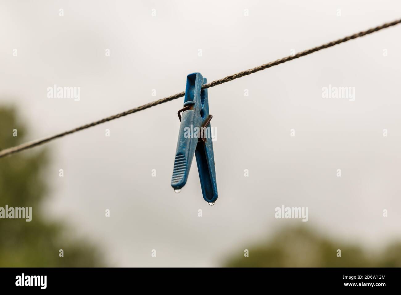 clothespin hanging from a rope. A clothespin hangs from the clothesline ...