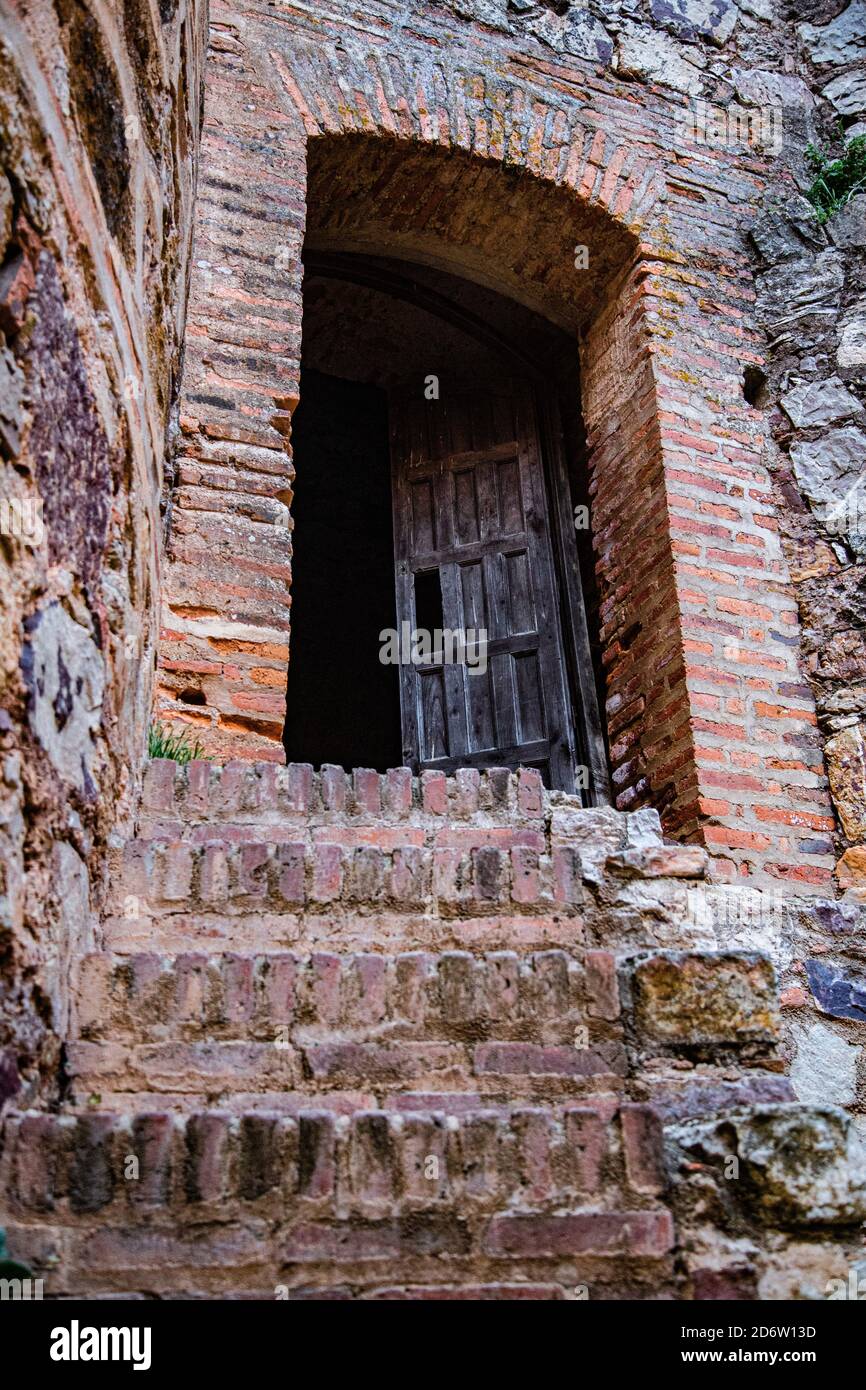 Castle interior door with red brick frame Stock Photo - Alamy