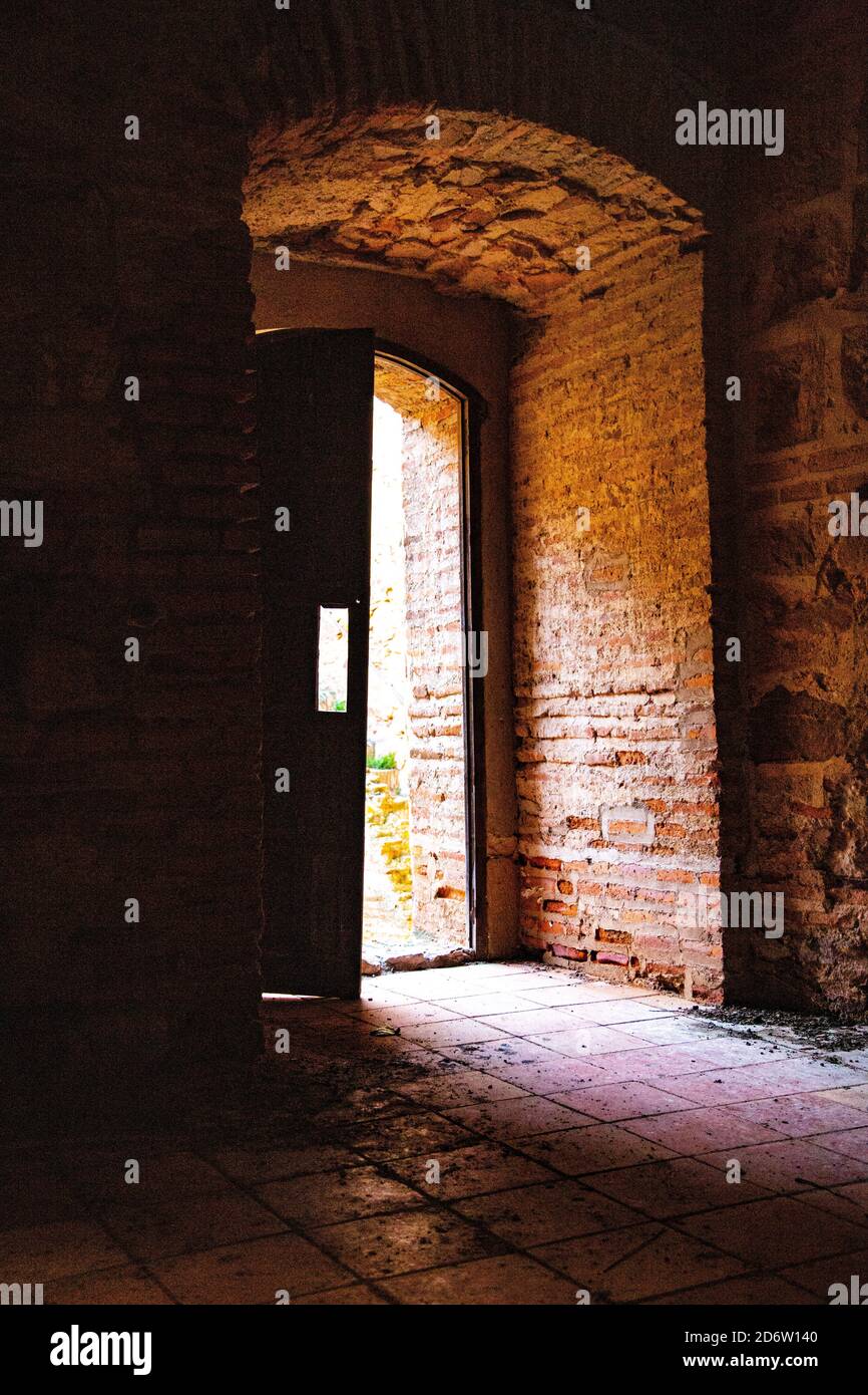 Wooden door in castle interior with red brick walls Stock Photo - Alamy