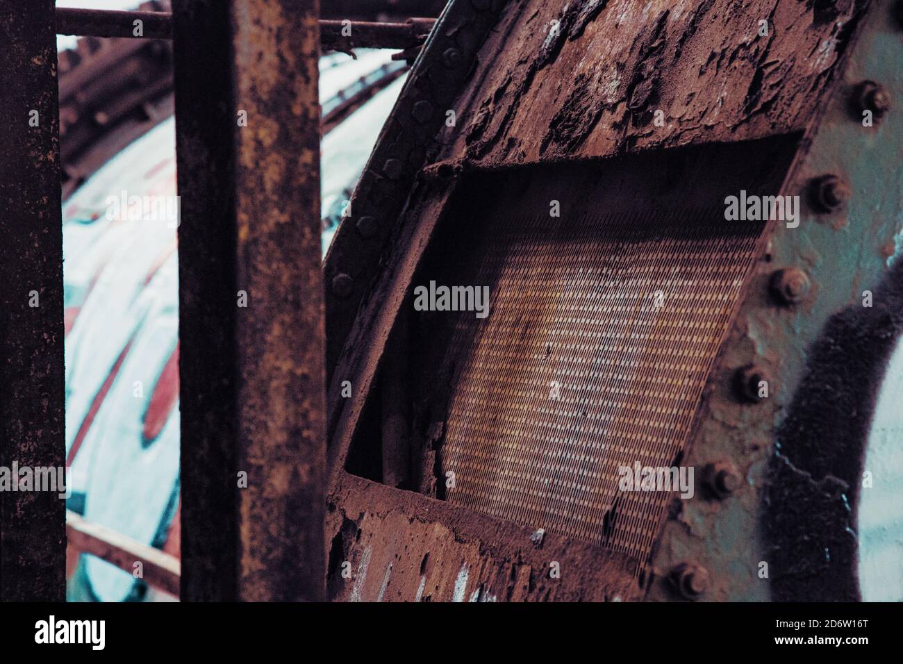 Rusty iron hopper with gratings on metal frame Stock Photo - Alamy