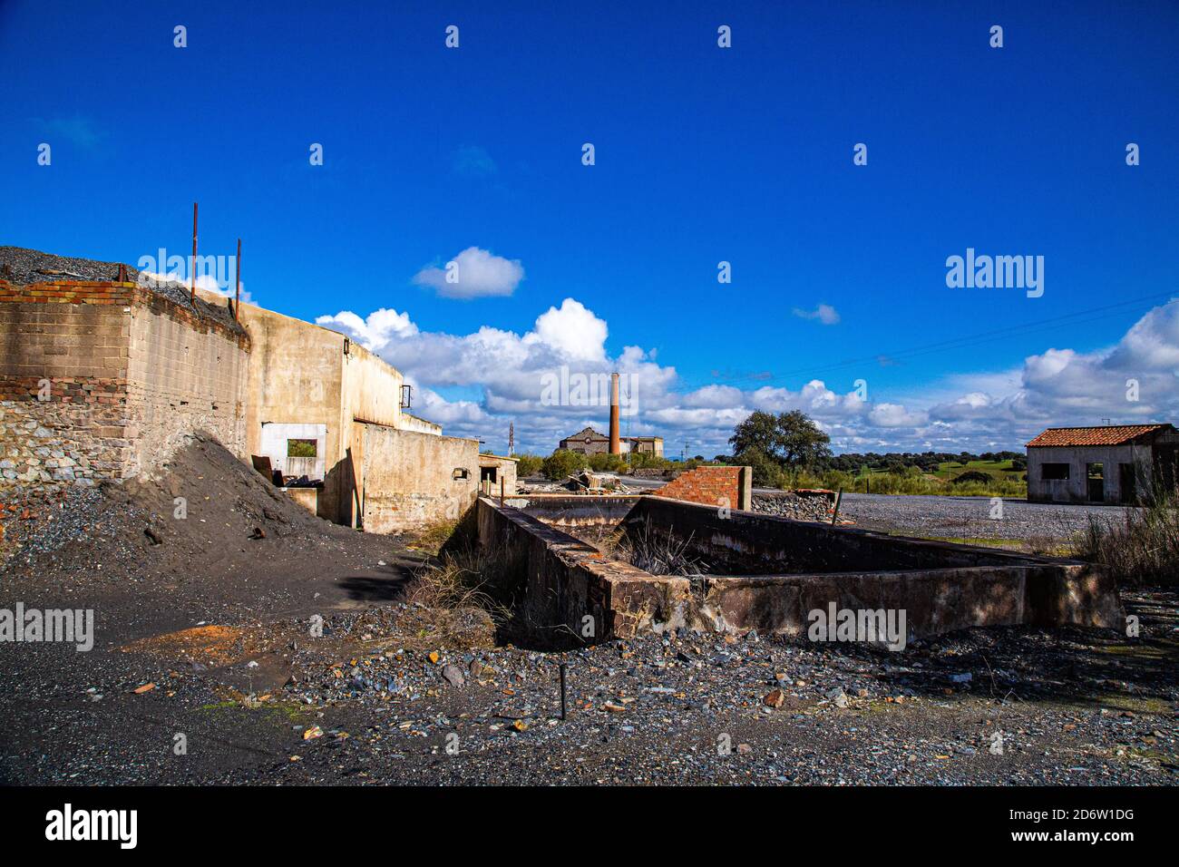 Ruined building complex with polluted soil and blue sky Stock Photo - Alamy