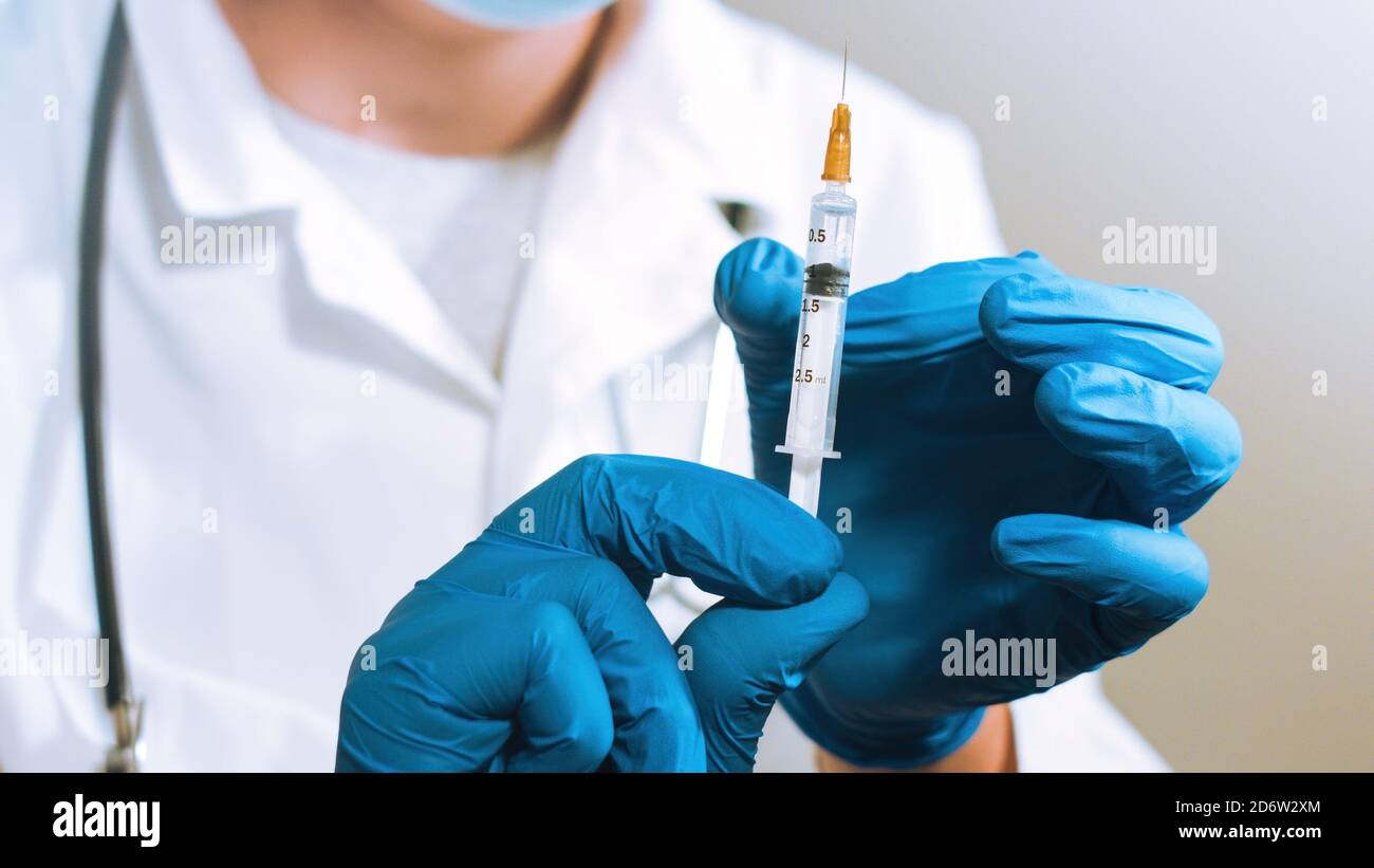 Coronavirus vaccine vial and syringe getting filled for injection Stock ...