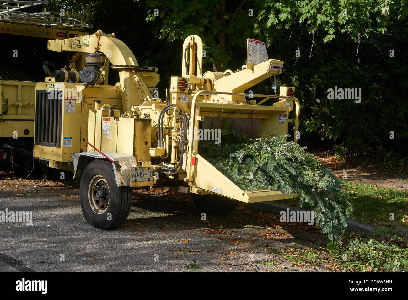 A diesel tree chipper machine or woodchipper parked on a residential ...