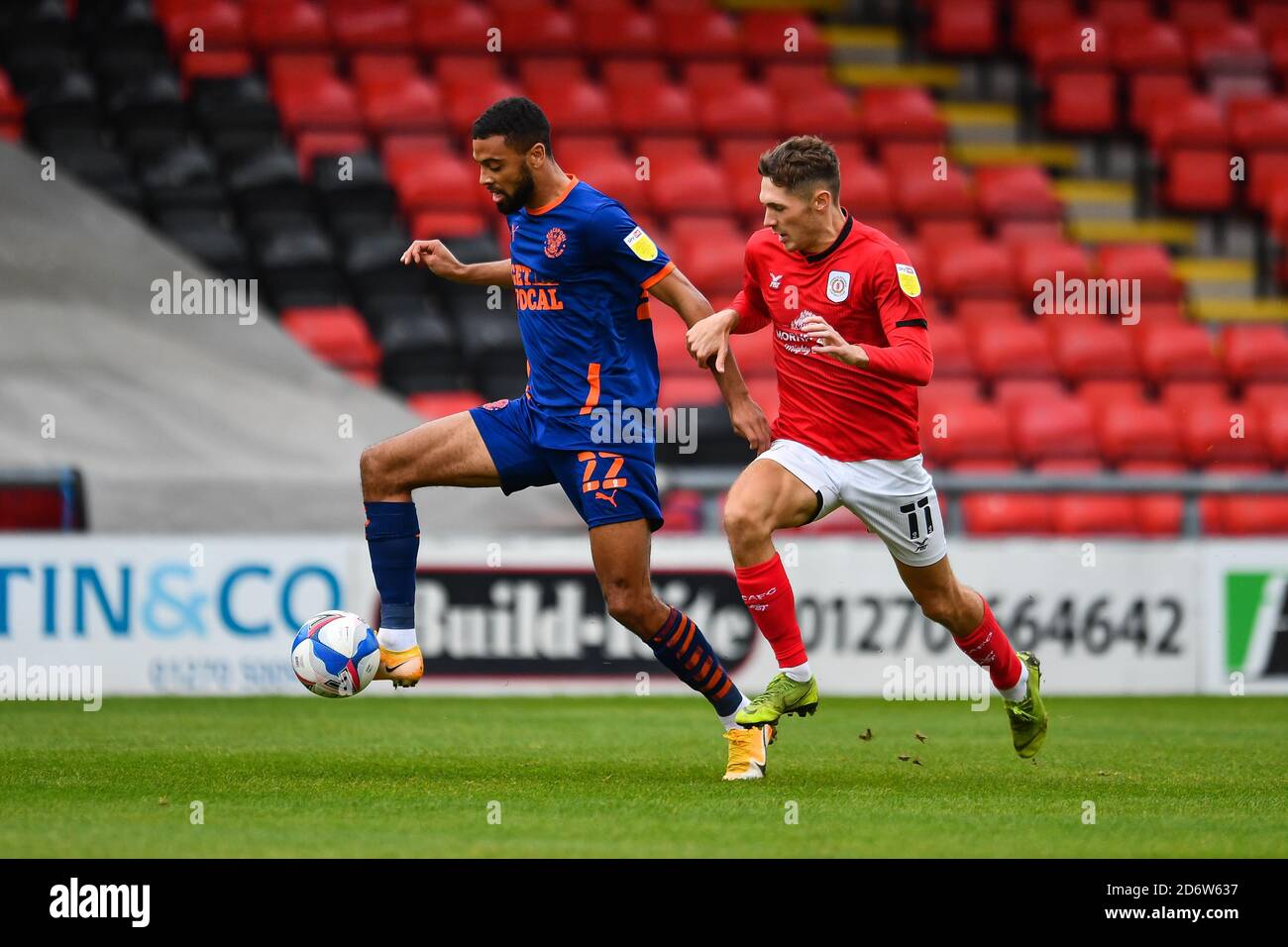 CJ Hamilton (22) of Blackpool holds off Callum Ainley (11) of Crewe ...