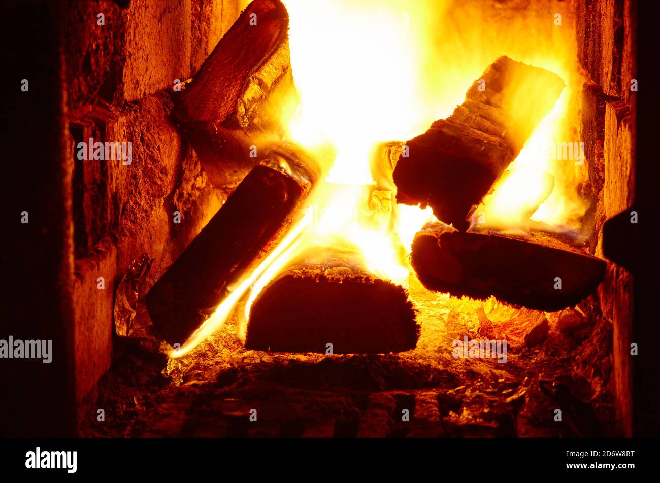 Crest of flame on burning wood in fireplace. Close-up of fire in hot ...
