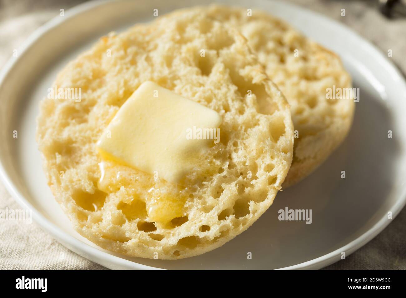 Homemade Toasted English Muffins with a Tab of Butter Stock Photo - Alamy