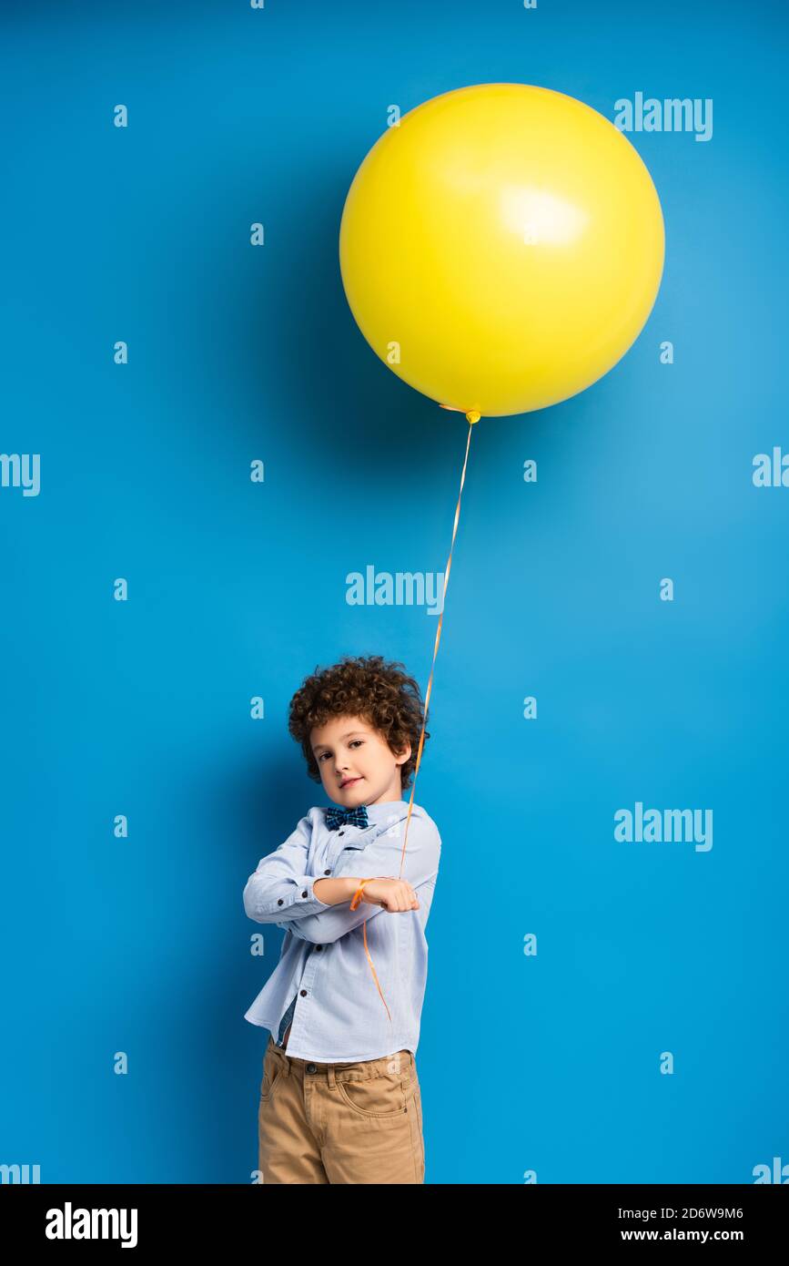 Boy holding big balloon hi-res stock photography and images - Alamy