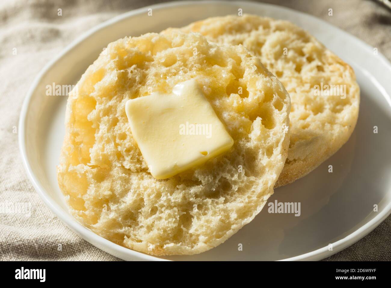 Homemade Toasted English Muffins with a Tab of Butter Stock Photo - Alamy