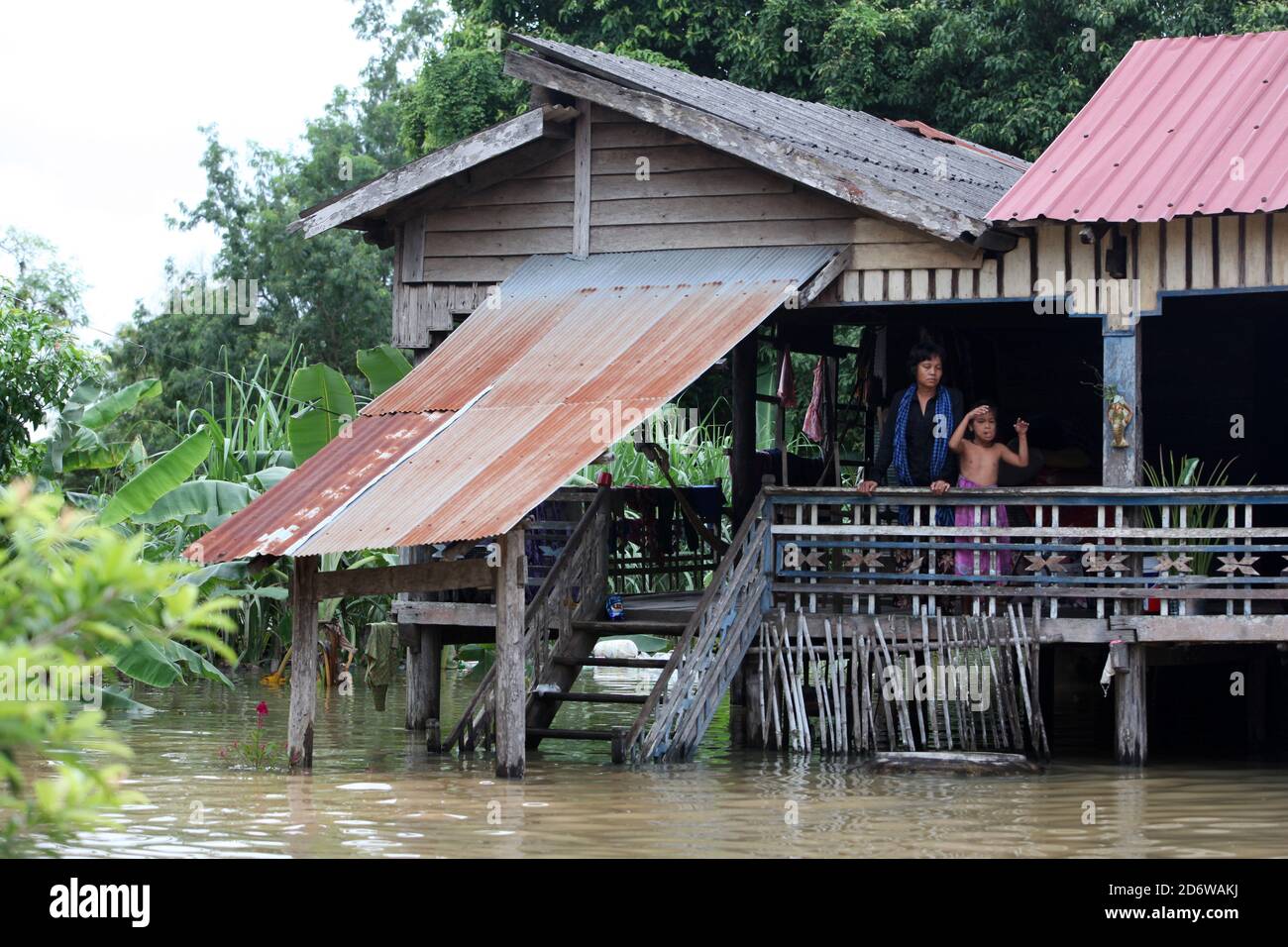 Phnom Penh. 18th Oct, 2020. People stand in their flooded house in O ...
