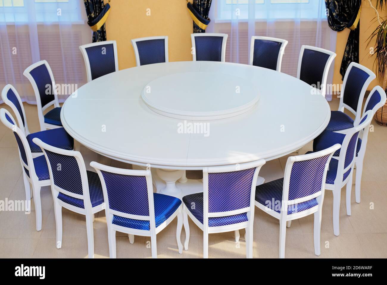 Empty white round conference table and chairs. Diplomatic background ...