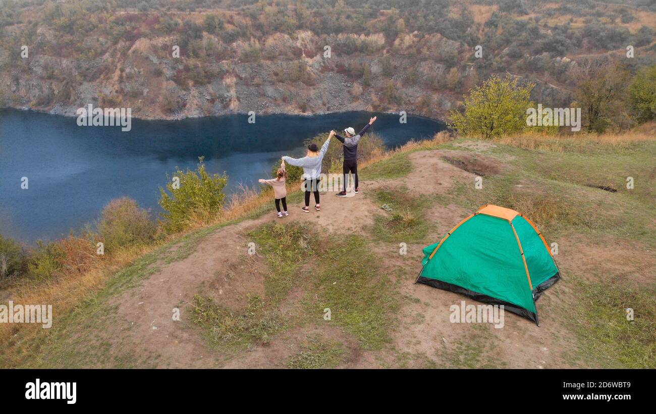 Aerial top view of family in campsite from above, parents and kid relax ...