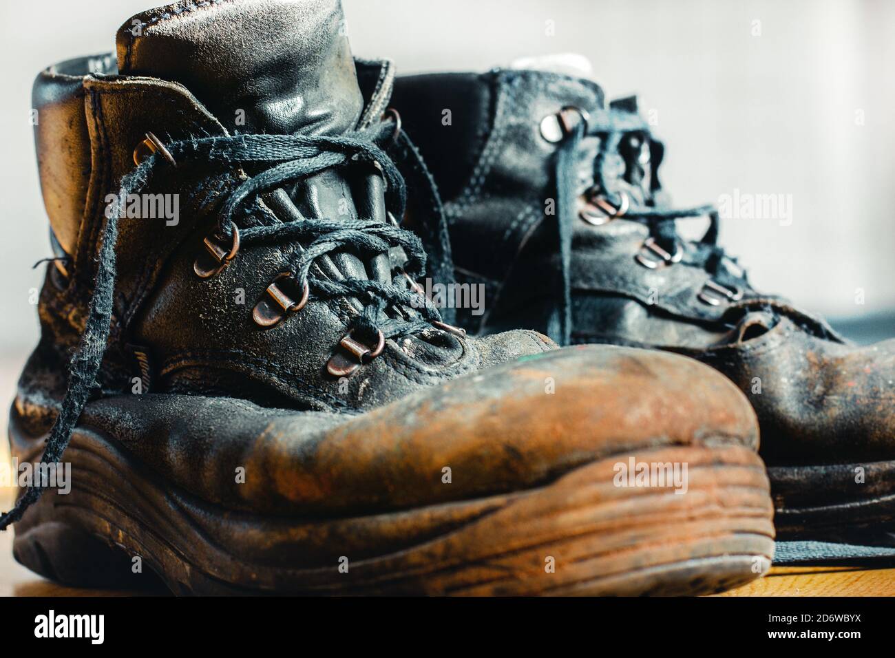 Old worn-out workman's shoes. Shoes that require repair or replacement ...