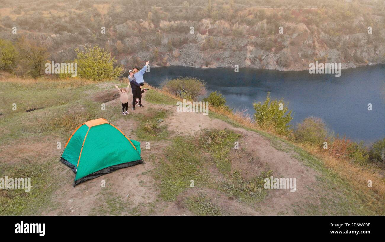 Aerial top view of family in campsite from above, parents and kid relax ...