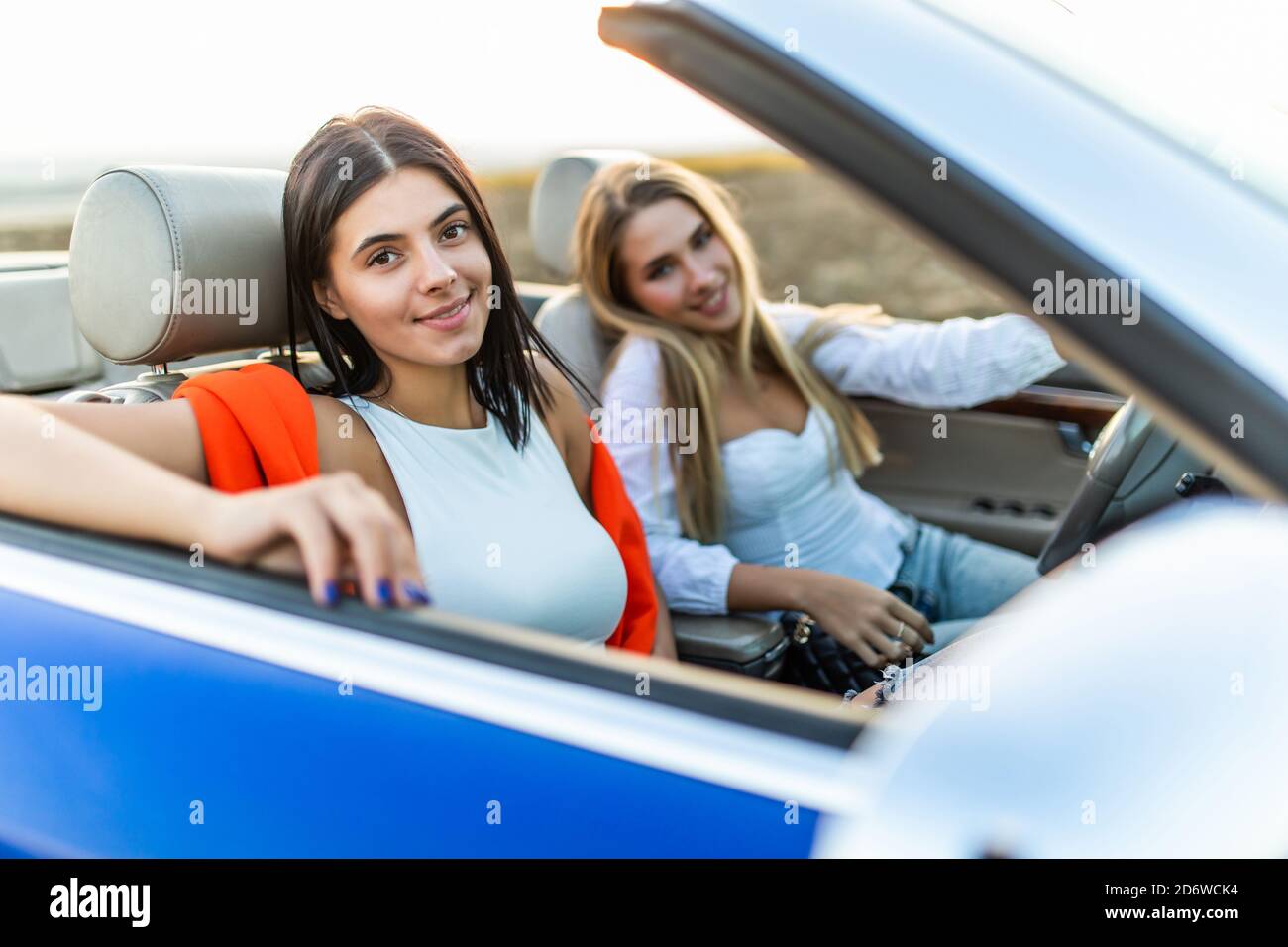 Two women and one man give five on the car on sunset Stock Photo - Alamy