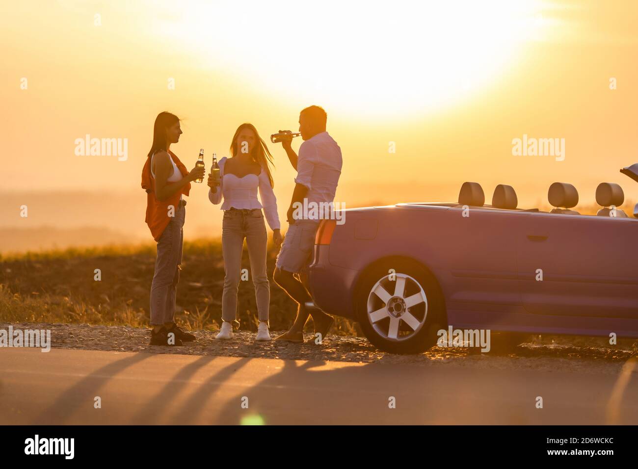 Group of happy friends making party near car. Young people having fun ...