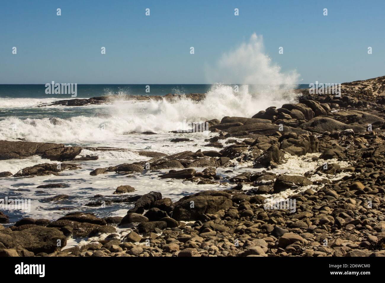 Waves crashing spectacular against the boulder strewn shore of the ...