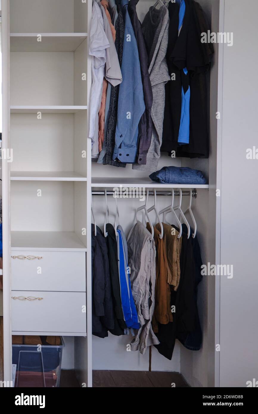 Wardrobe section with hanging things and clothes Stock Photo - Alamy