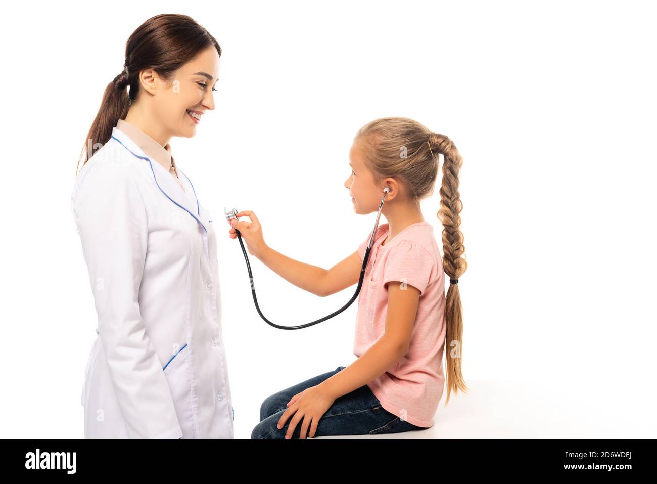 Child holding stethoscope near smiling doctor isolated on white Stock ...