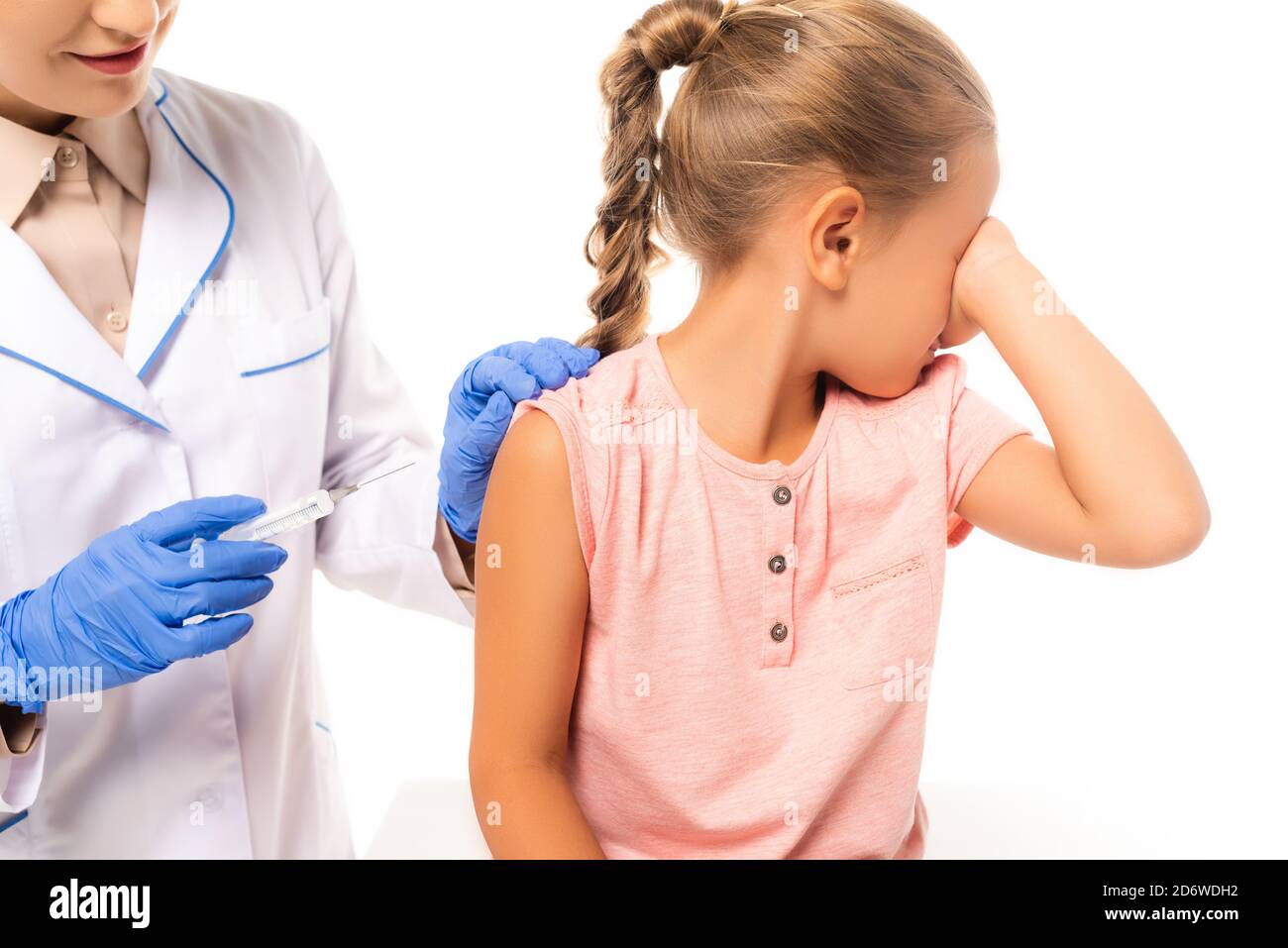 Pediatrician holding syringe near frightened child isolated on white ...