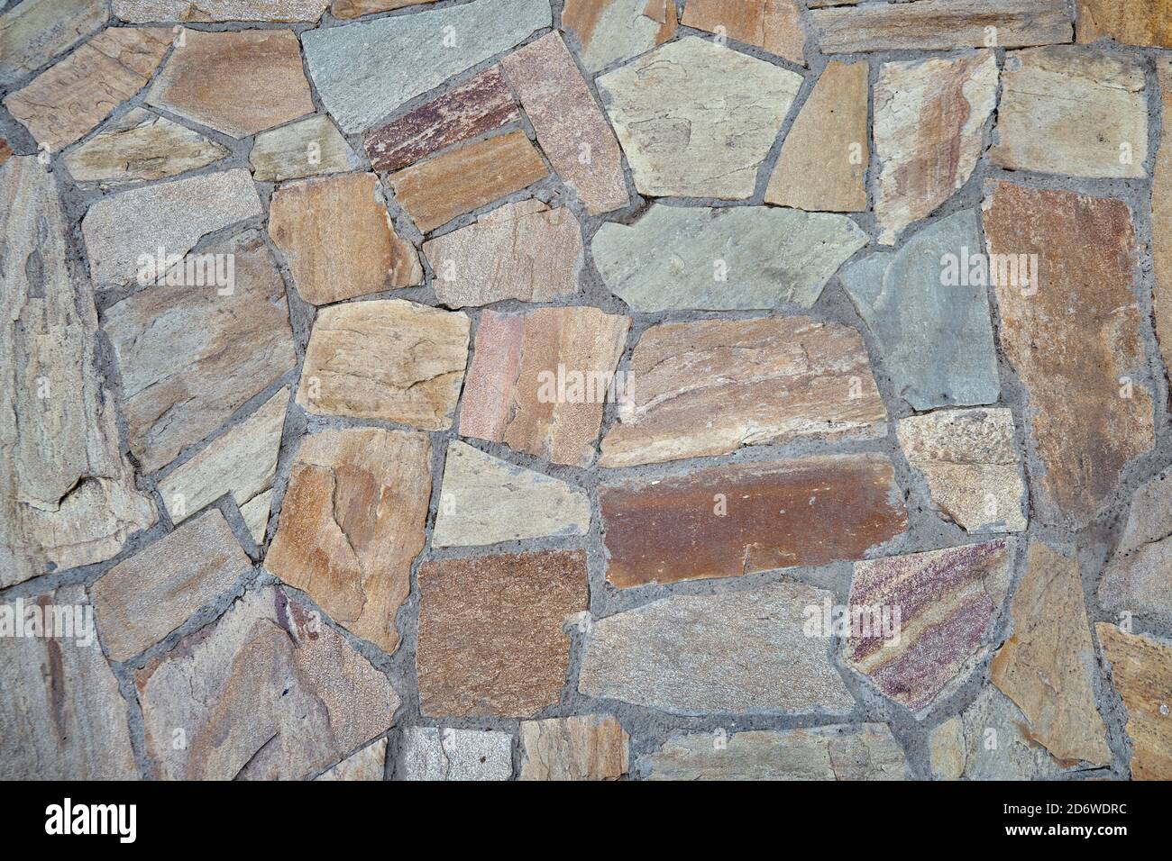 Texture of old irregular shaped tiles made of stones of different sizes ...