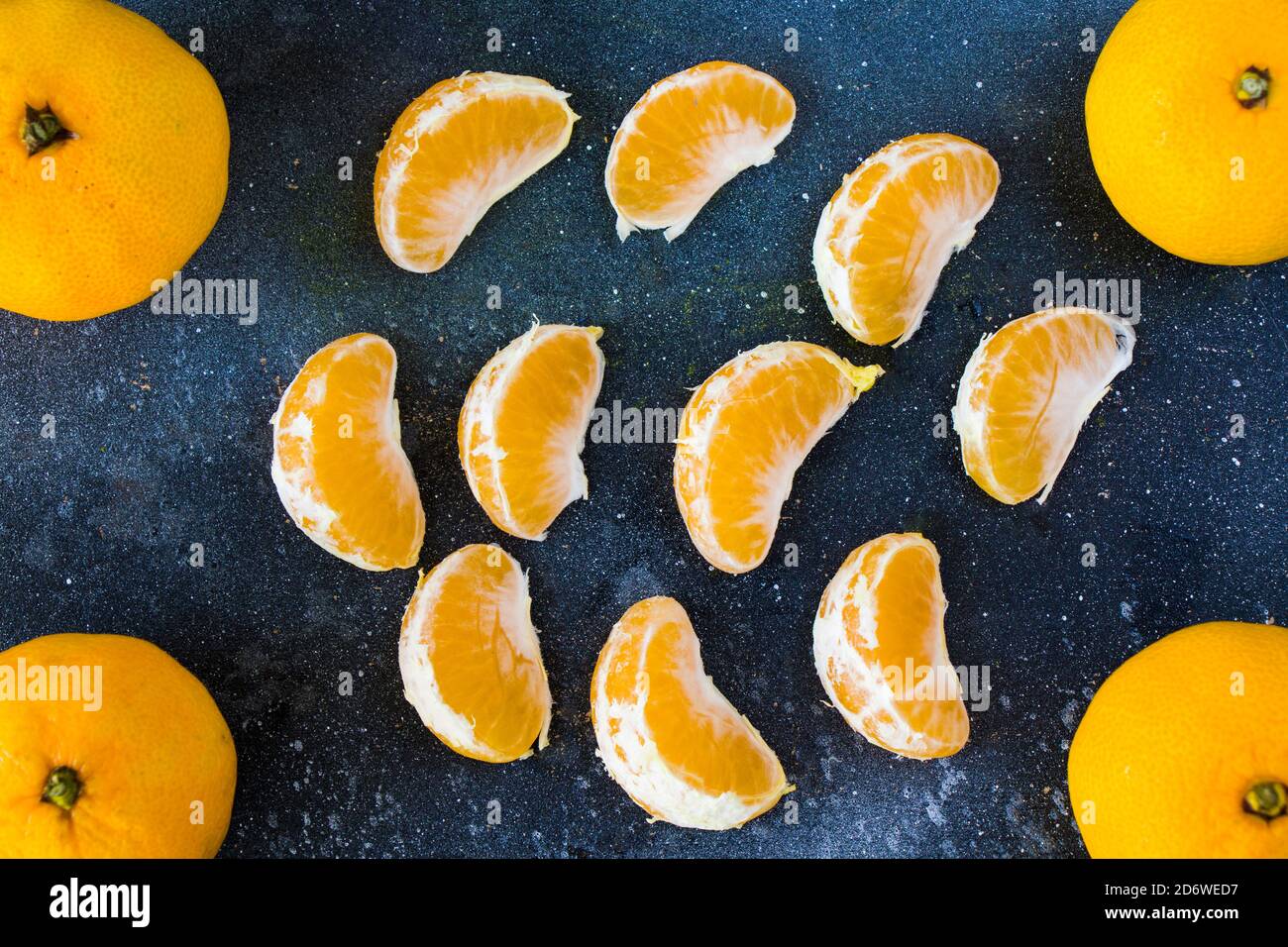 large group of the clementines on the blue background, orange color ...