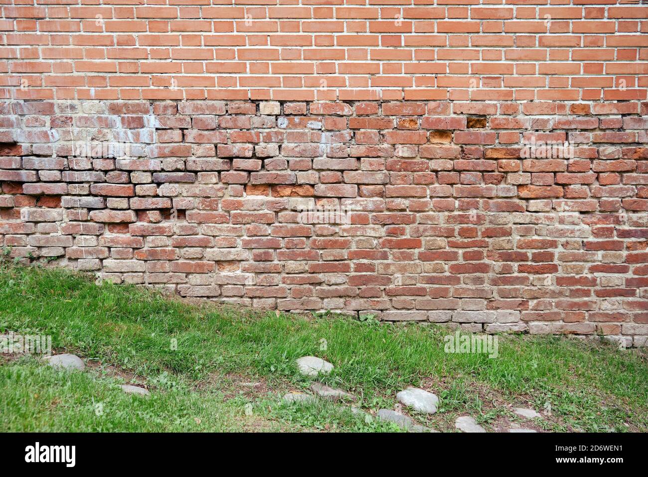 Texture of brick wall with grass at the bottom, background border of ...