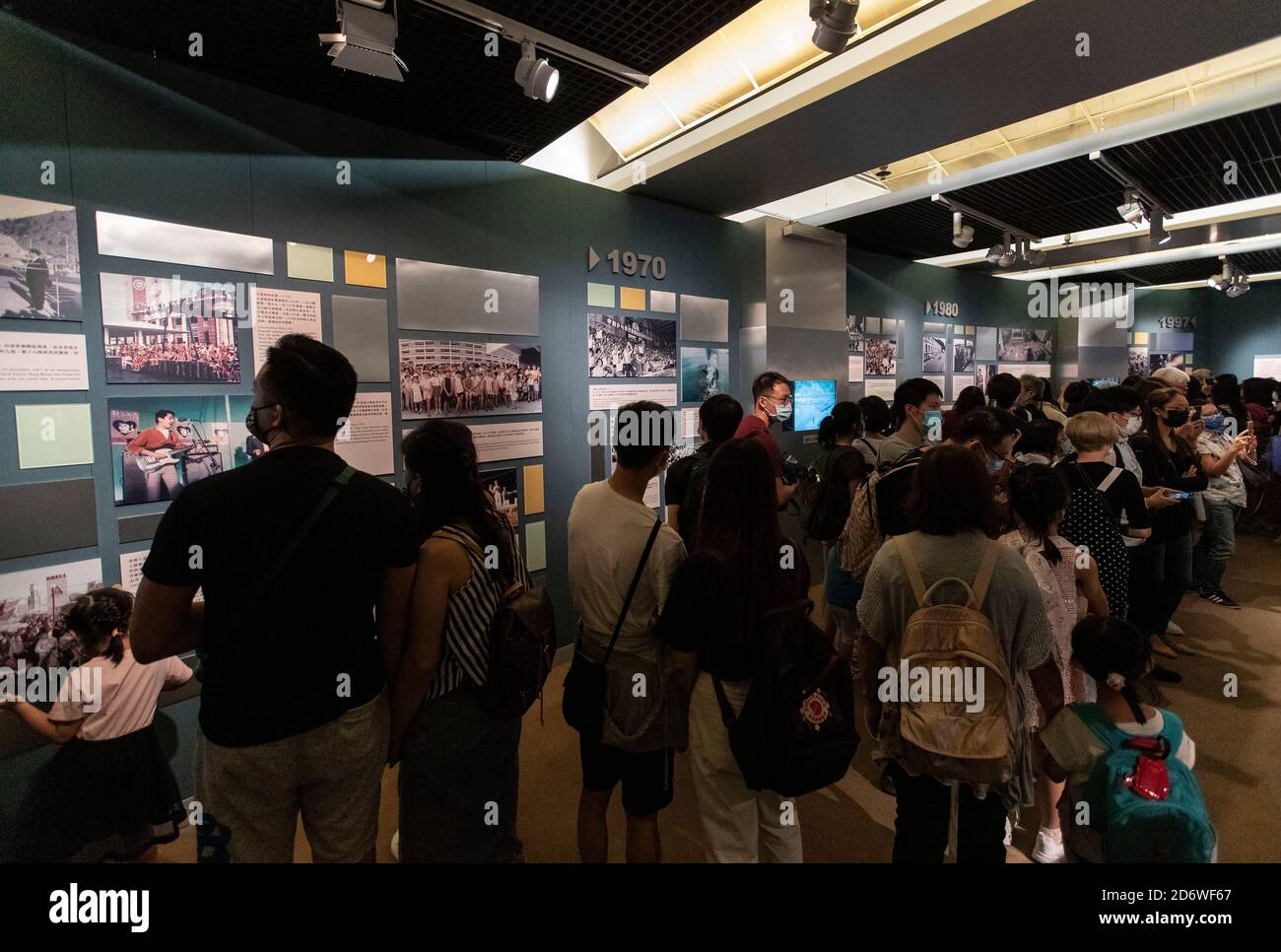Visitors look at the information timeline at "The Hong Kong Story ...