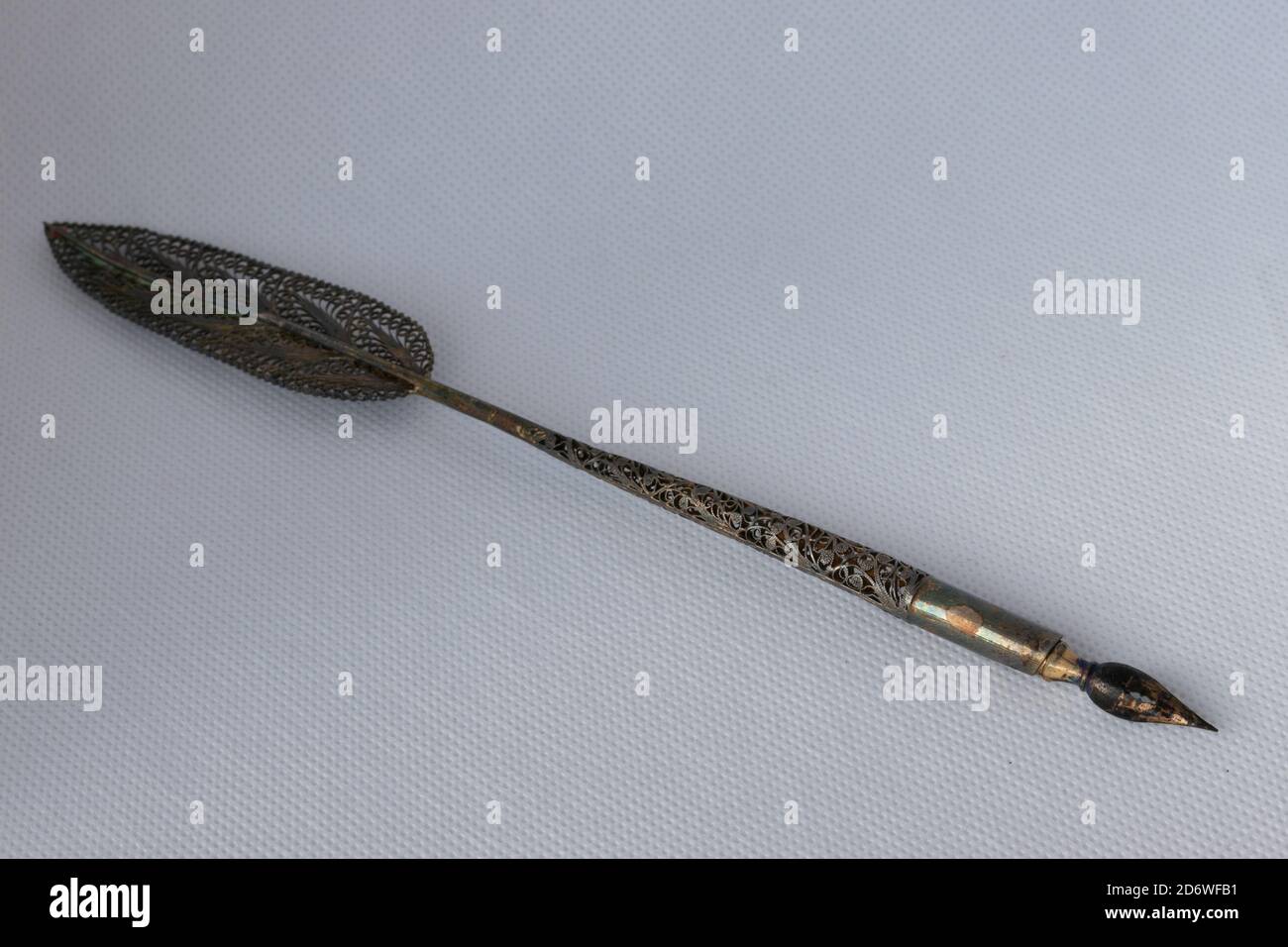 Old ink pen with metal filigreed and ink bottle isolated on white ...