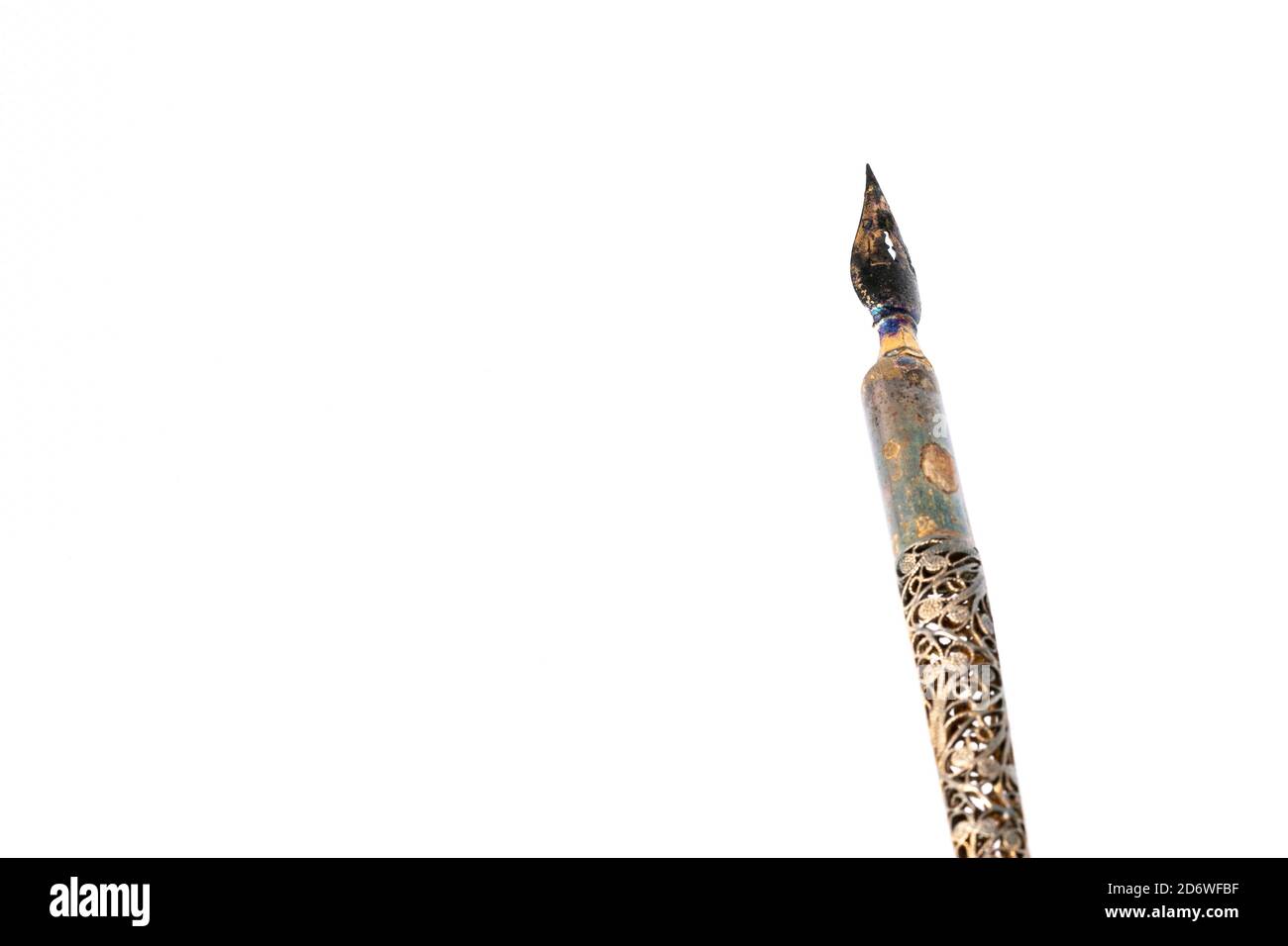 Old ink pen with metal filigreed and ink bottle isolated on white ...
