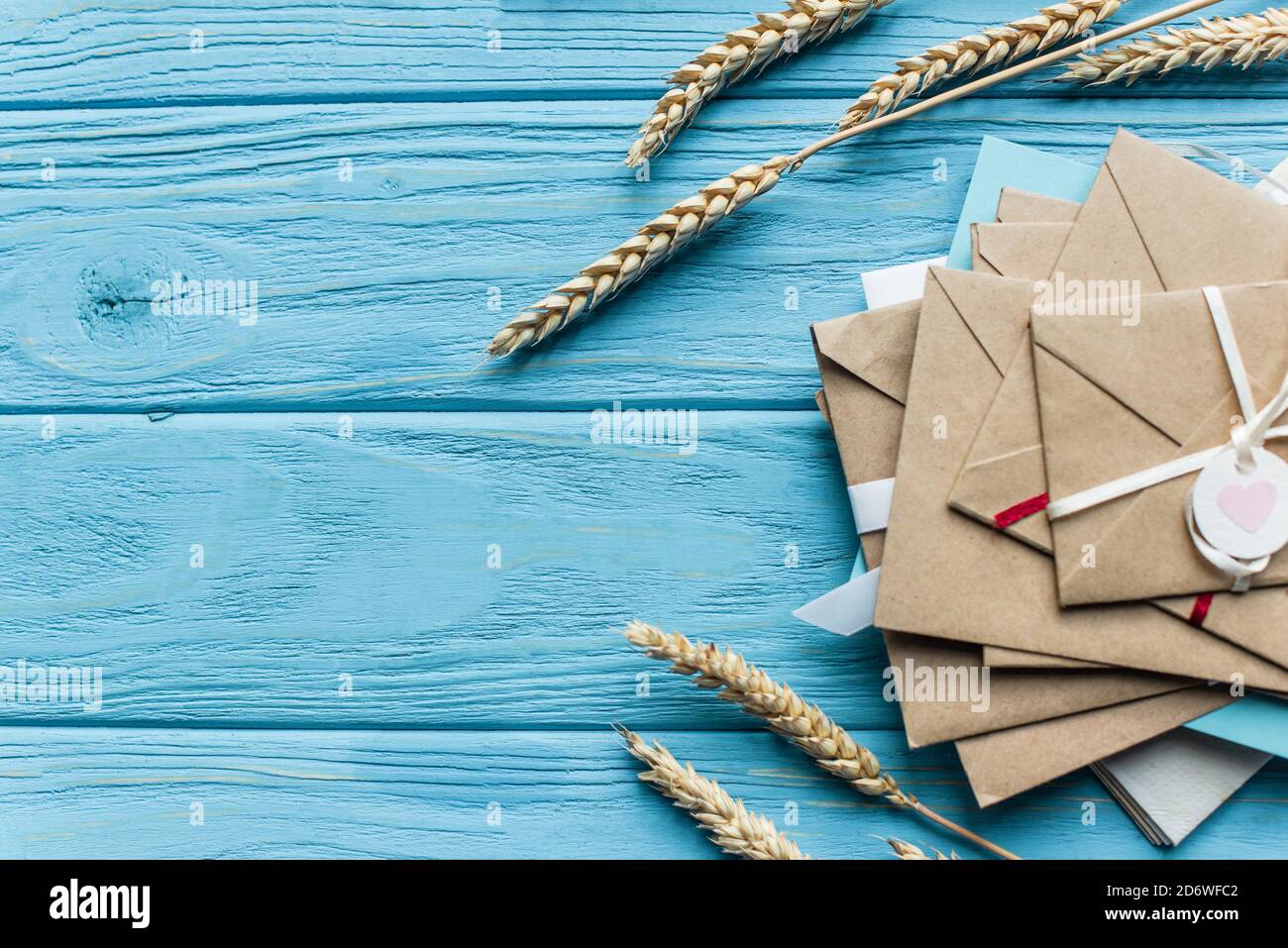 top view of wooden blue background with envelopes and wheat ears Stock ...