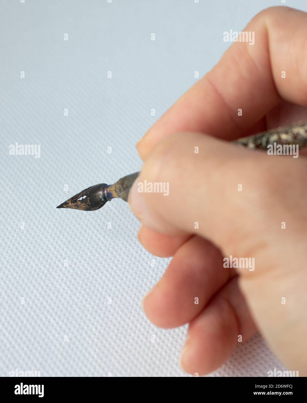 Old ink pen with metal filigreed and ink bottle isolated on white ...