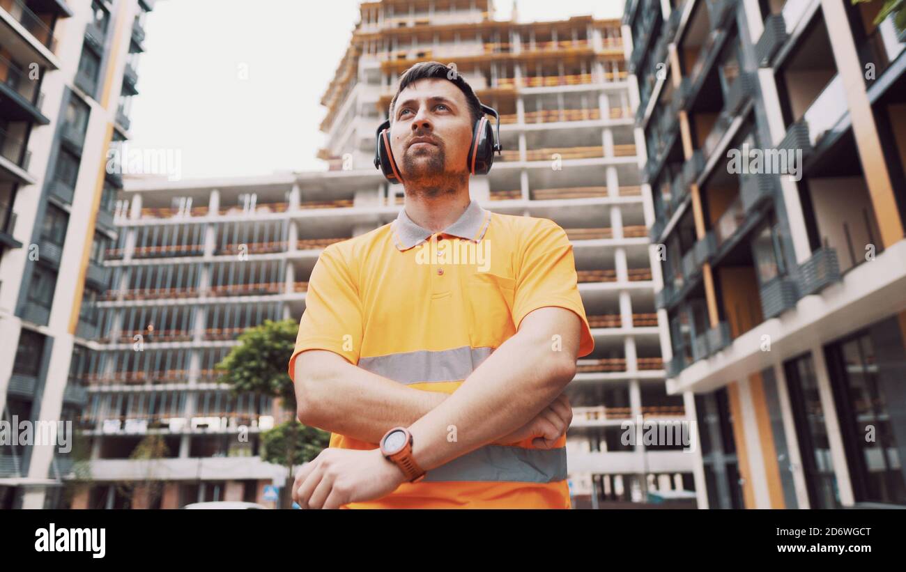 Man wearing safety equipment hearing protection. Worker wearing noise ...