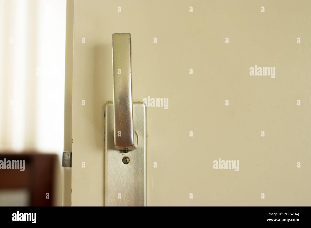 Closeup of silver colored vertical door handle on white door Stock ...
