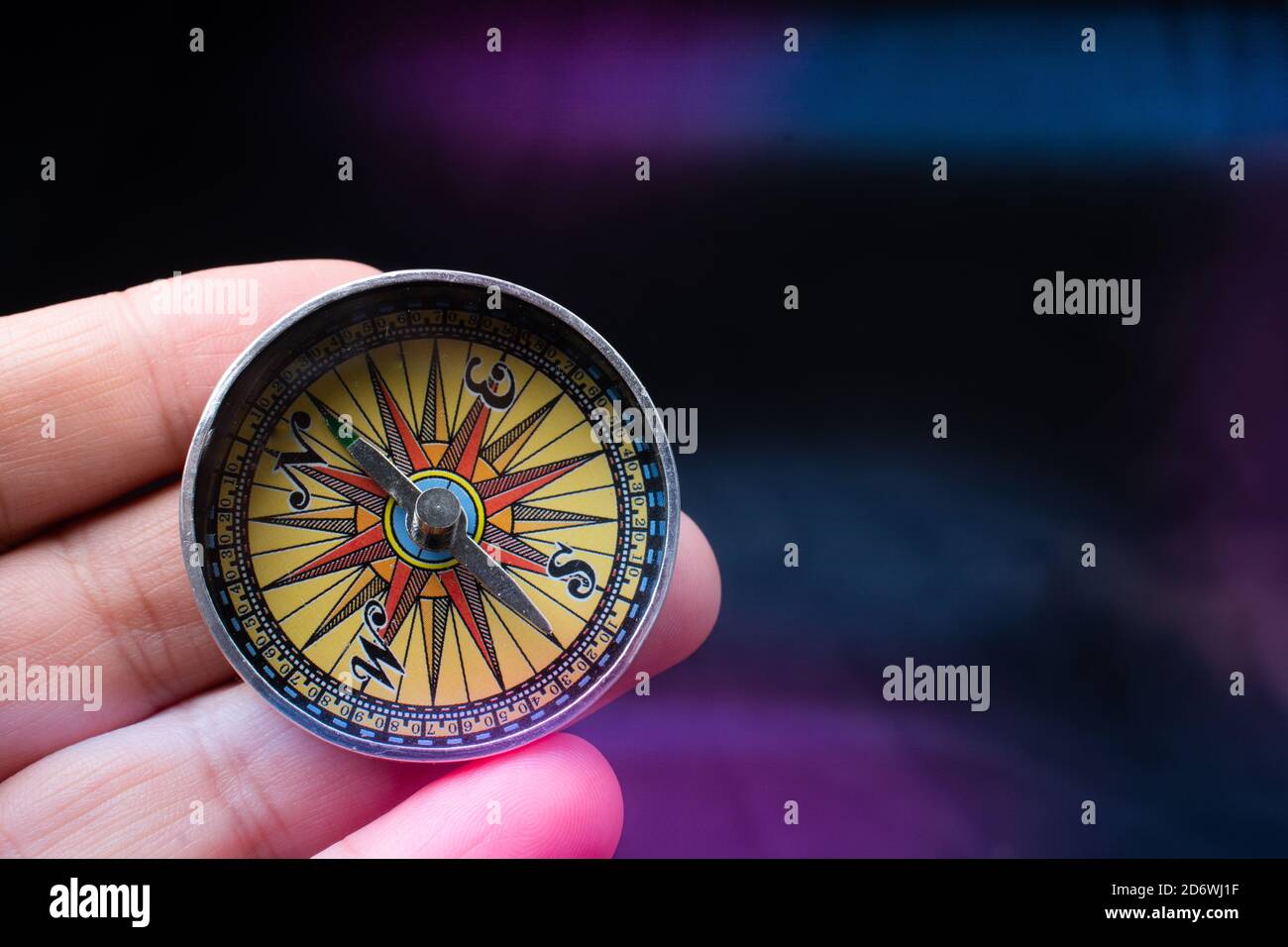 Compass tool in hand o as travel concept Stock Photo - Alamy