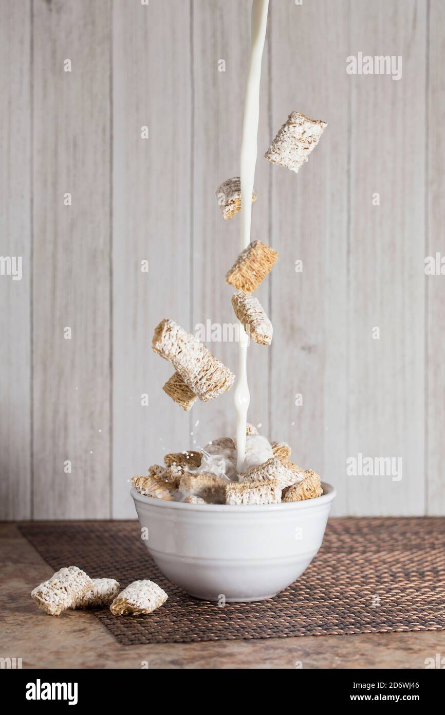 Wheat Cereal and Milk Splash in a White Bowl Stock Photo - Alamy