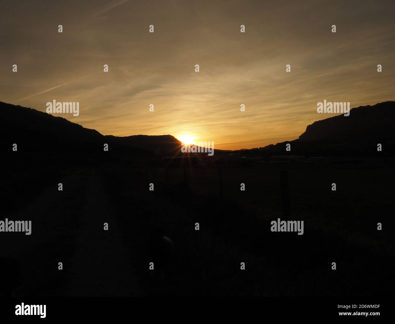 view of a sunset with mountains Stock Photo - Alamy