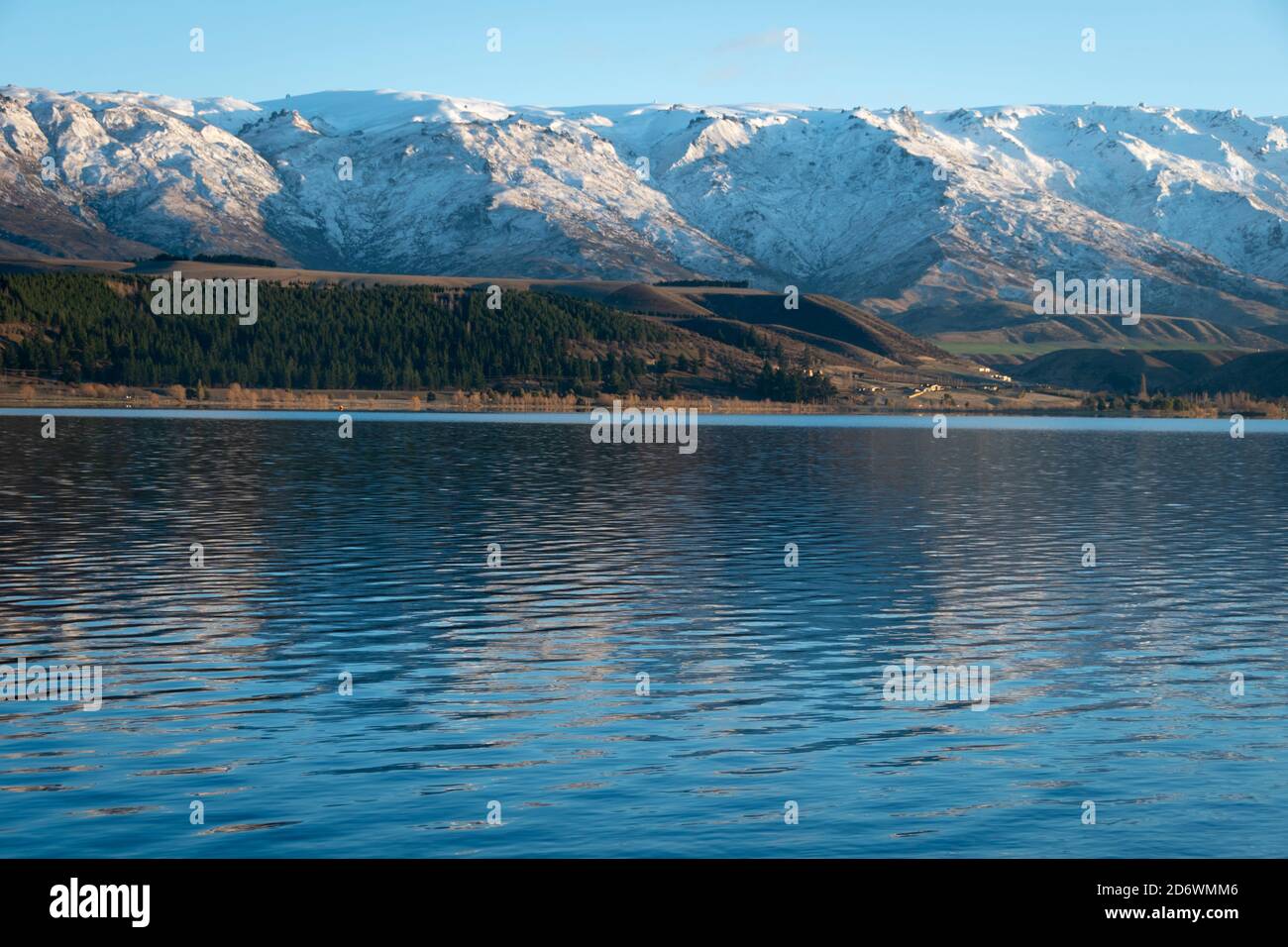 Snow capped mountains on Pisa Range, looking across Lake Dunstan ...