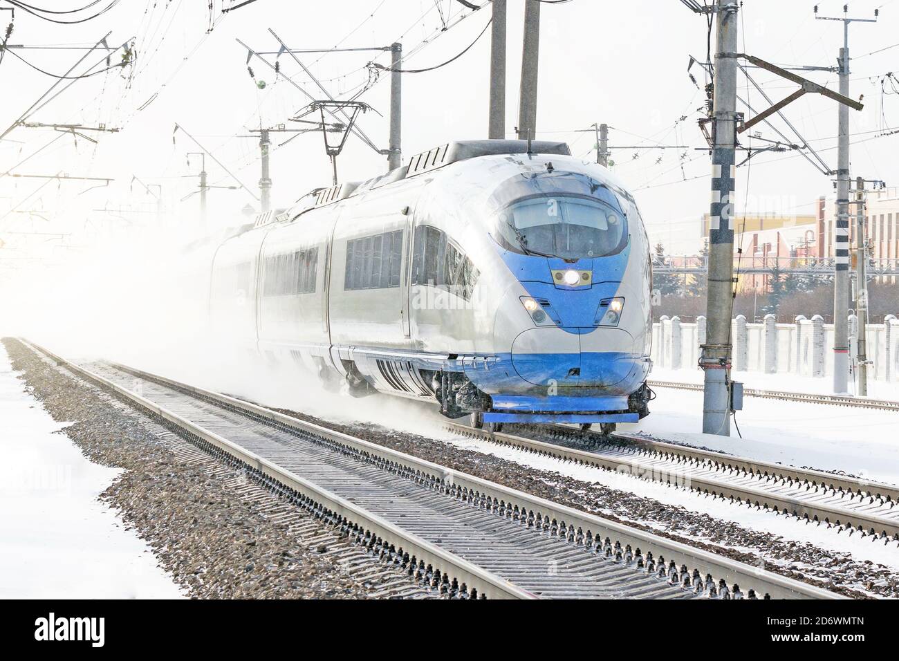 High-speed train rides at high speed in winter around the snowy ...