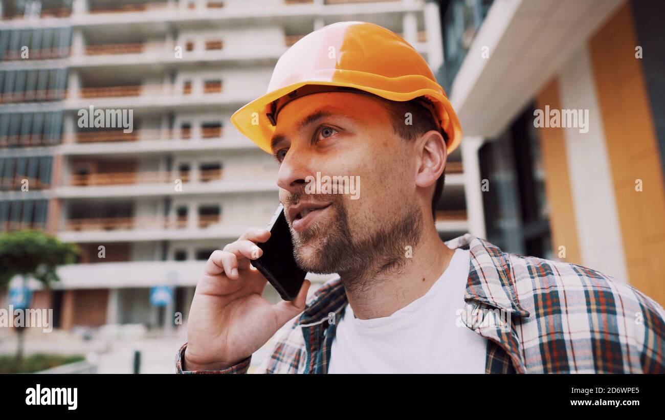 Engineer talking on phone. Architect using phone on construction site ...