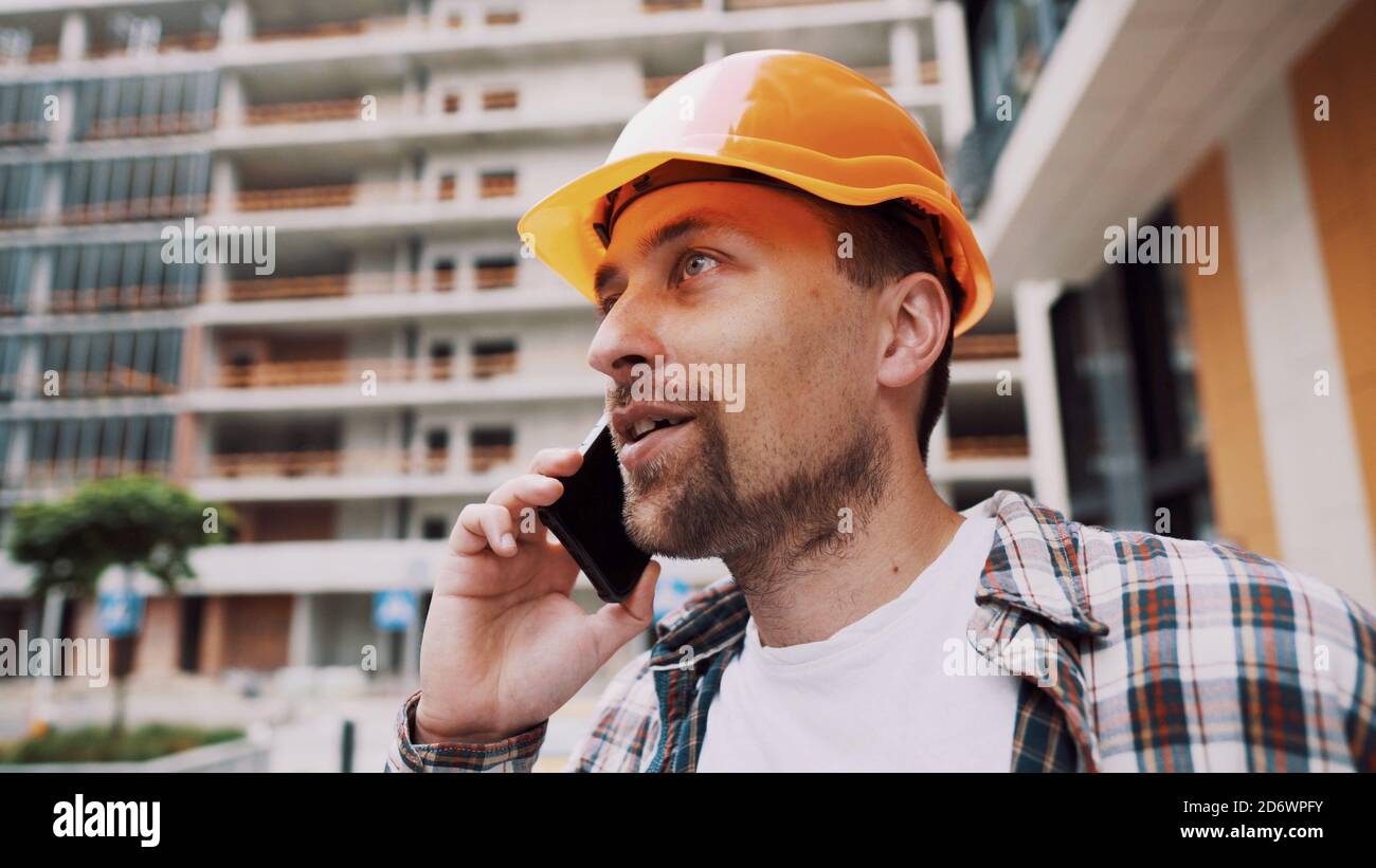 Engineer talking on phone. Architect using phone on construction site ...
