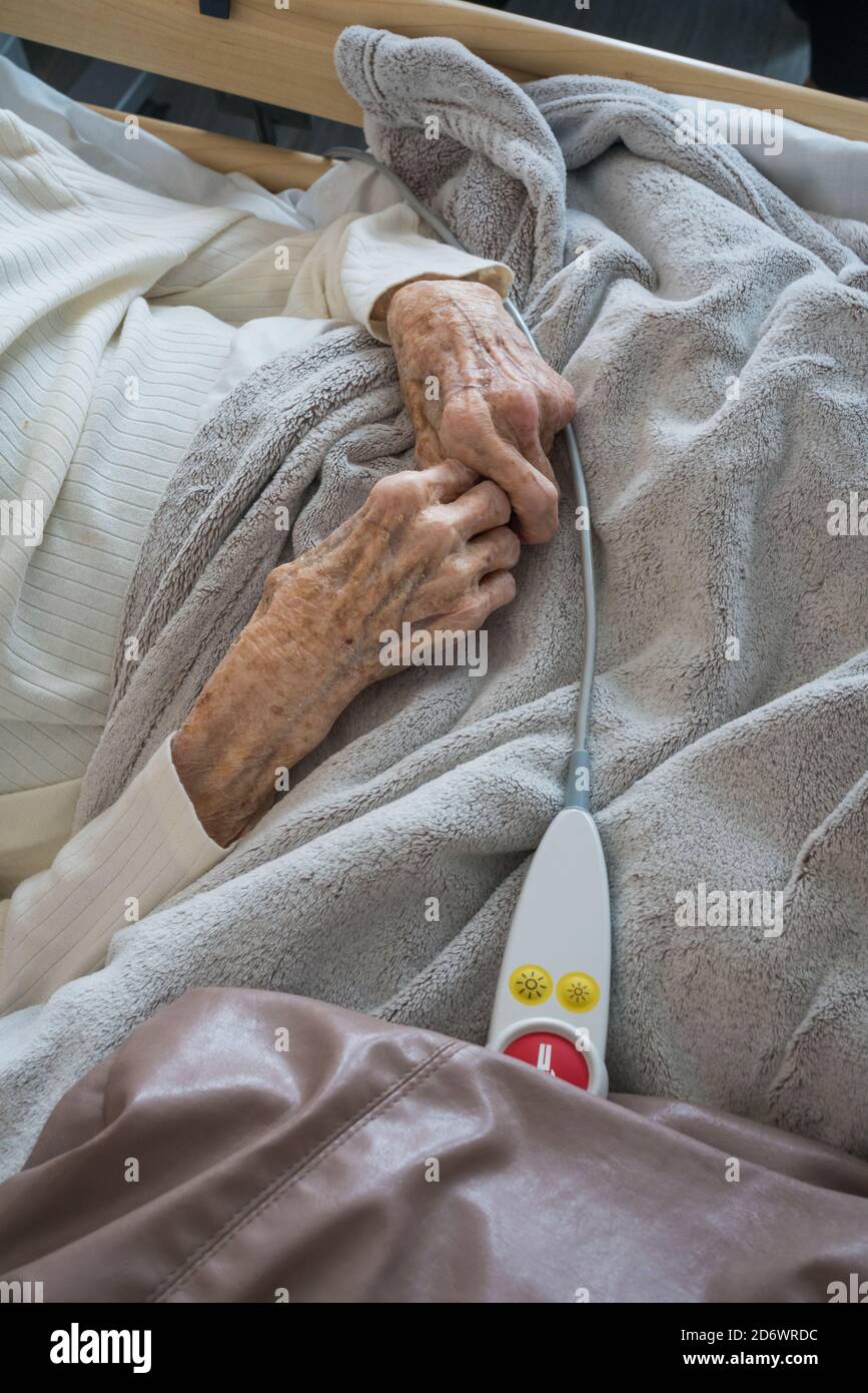 Elderly woman in hospital room, Nurse calling remote control , France ...